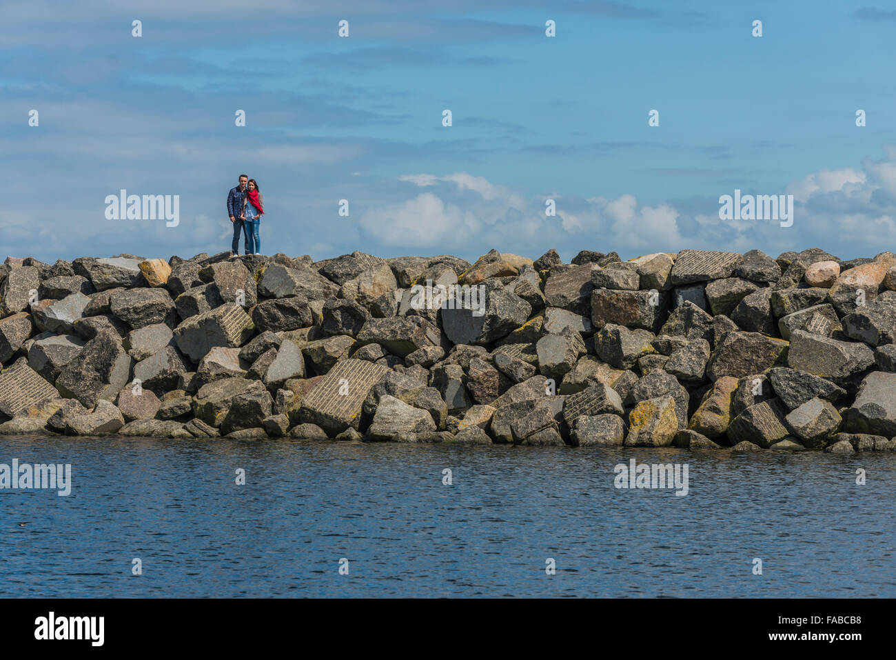 2 persons are standing on a Mole. Male and female at the Baltic sea ...