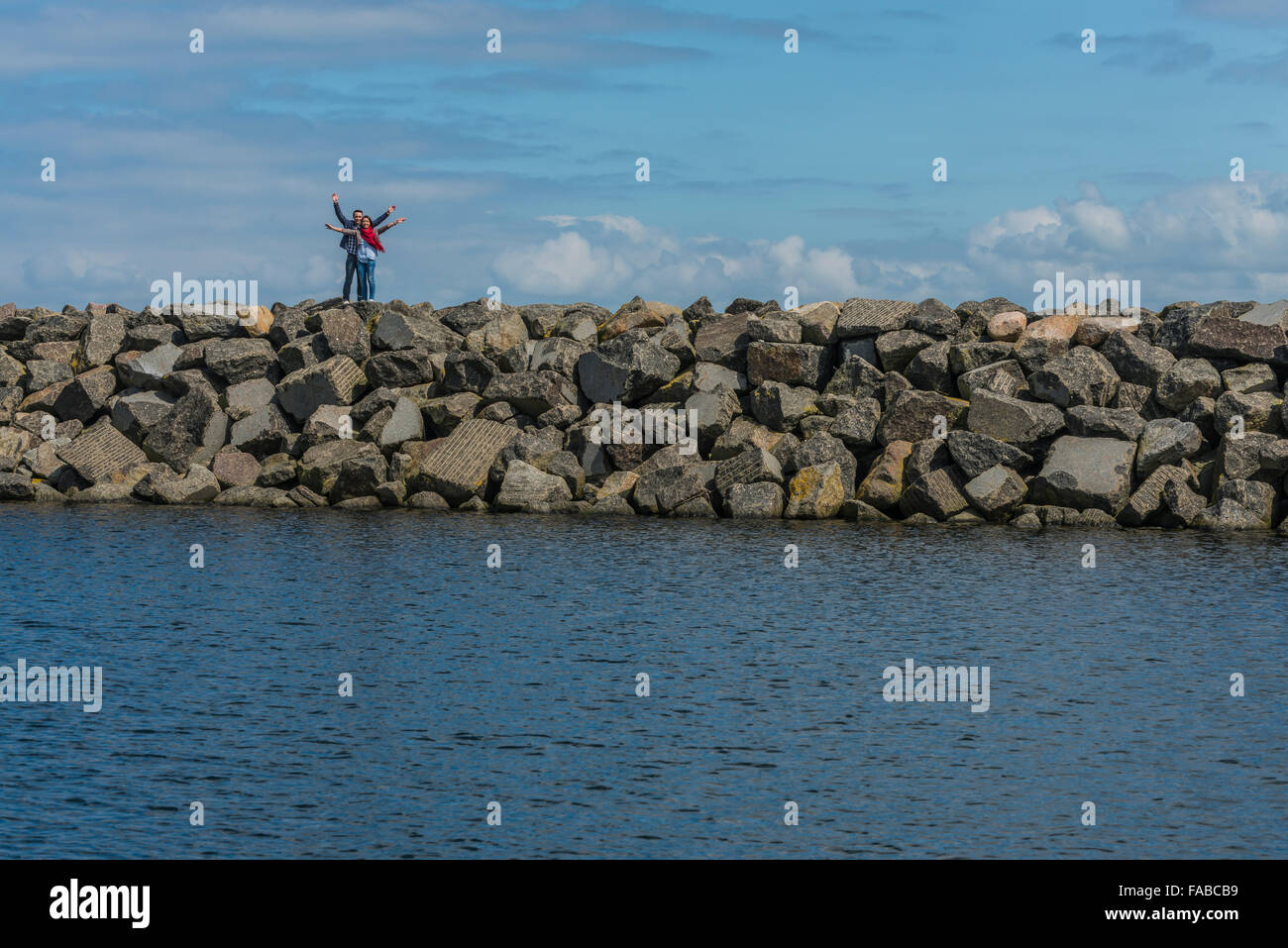 2 persons are standing on a Mole. Male and female at the Baltic sea ...