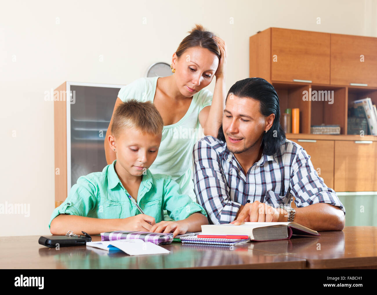 Teenager schoolboy and parents studying together Stock Photo - Alamy
