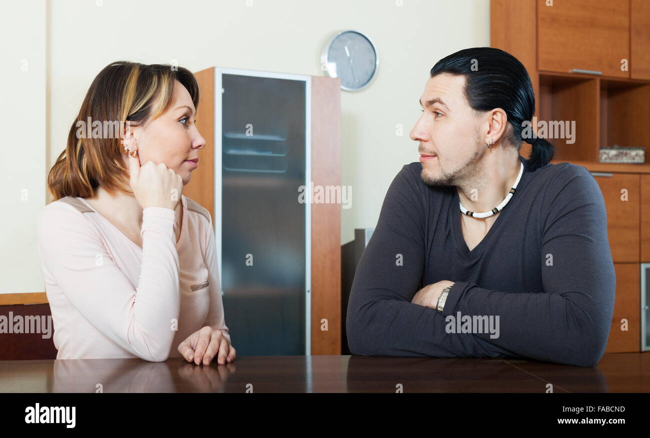 Ordinary couple talking in home interior Stock Photo - Alamy