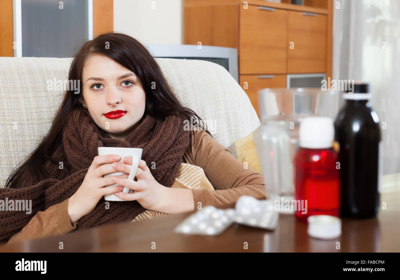 Sick girl with medications at table Stock Photo - Alamy