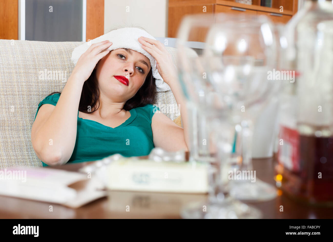 Woman having headache in morning after party Stock Photo - Alamy