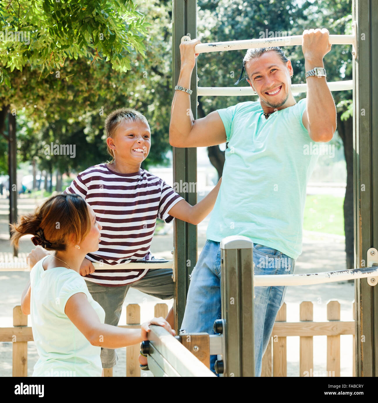 Middle-aged man with family training on chin-up bar in the yard Stock ...