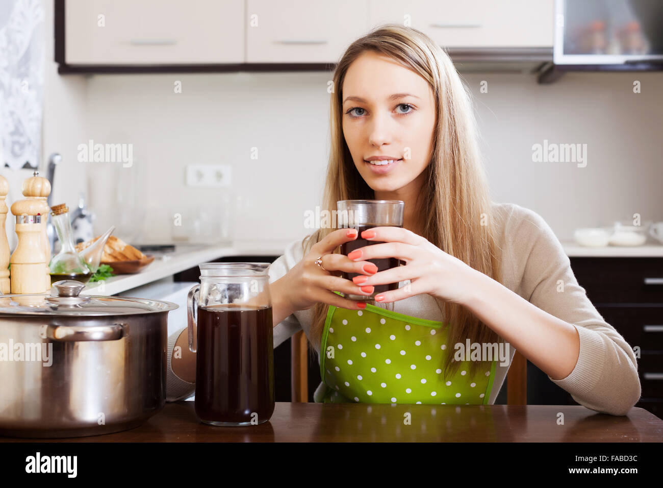 Woman drinking fresh quass from glass at home kitchen Stock Photo - Alamy