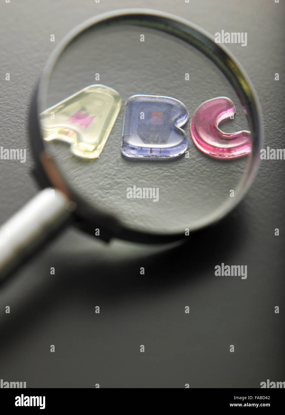 magnifying glass focus on alphabet a b c Stock Photo - Alamy
