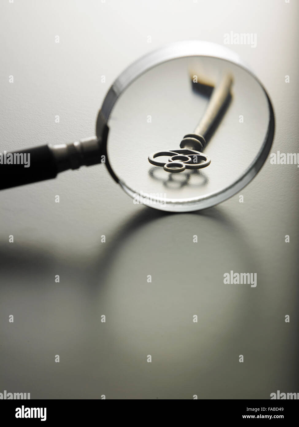 magnifying glass on a key Stock Photo - Alamy