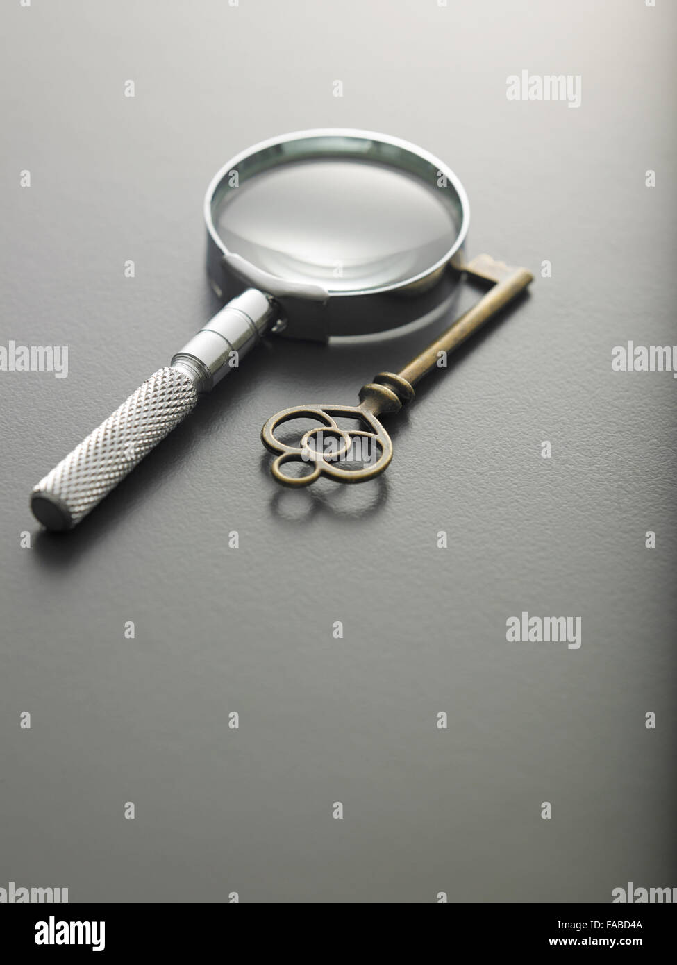 magnifying glass and a key Stock Photo - Alamy