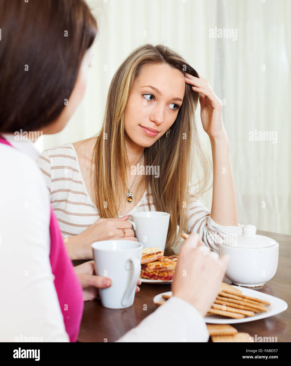 Unhappy woman telling to friend about her problems in home Stock Photo ...