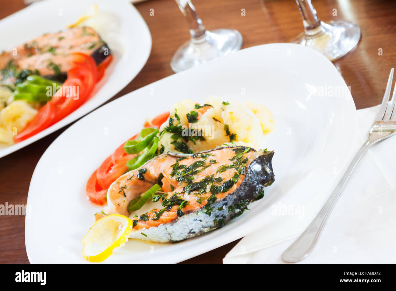 salmon fish on plate at table Stock Photo - Alamy
