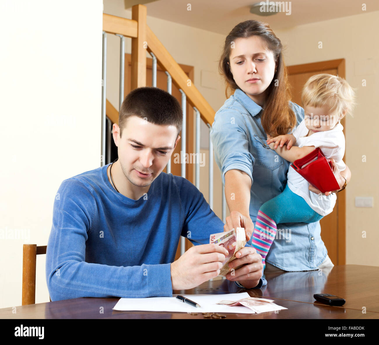 Quarrel in the family of three due to lack of money Stock Photo - Alamy