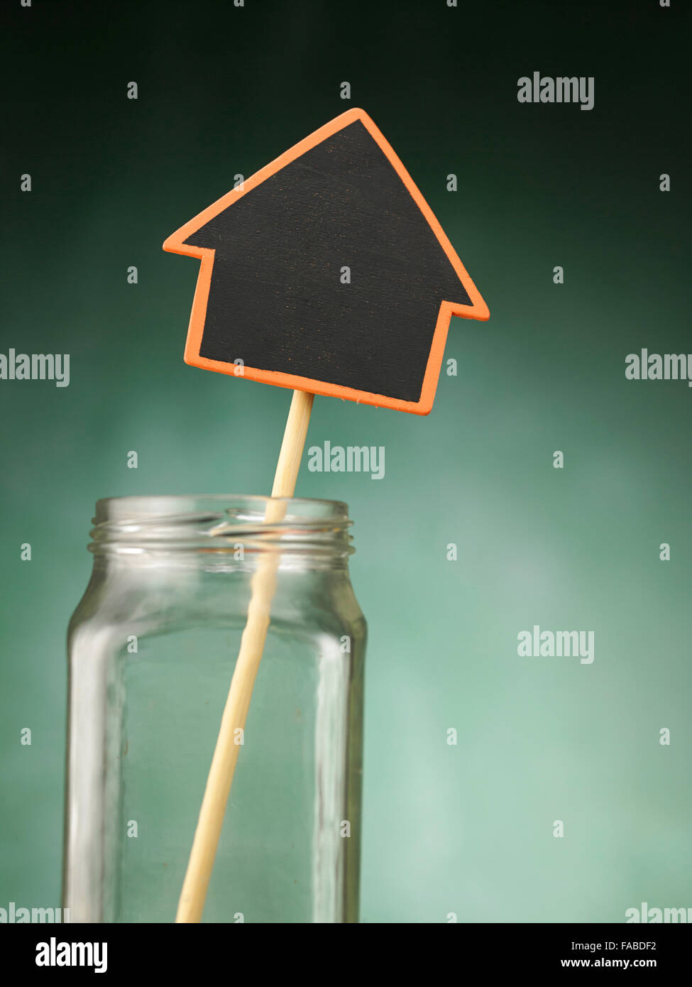 jar with black board house shaped Stock Photo - Alamy