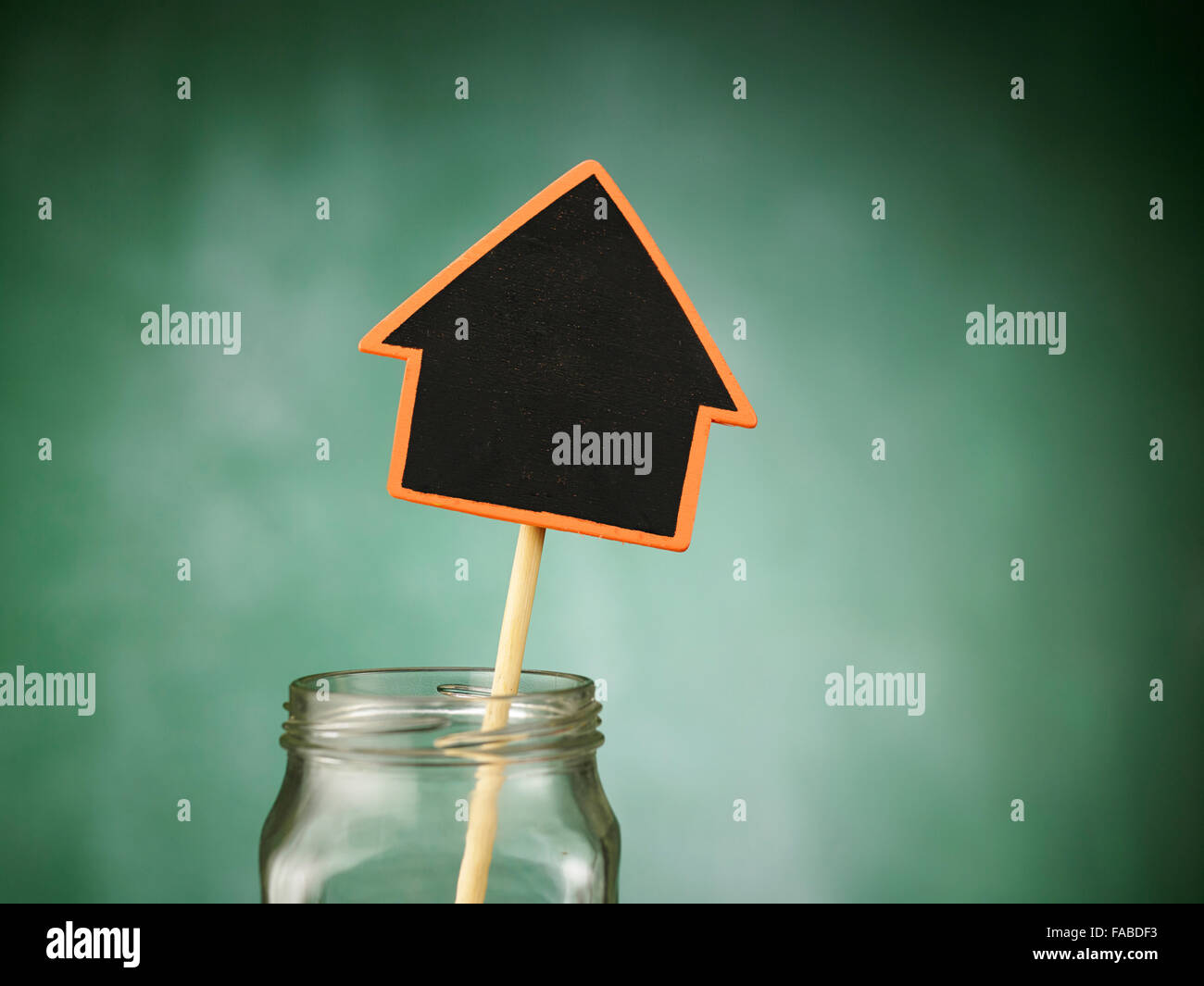 jar with black board house shaped Stock Photo - Alamy