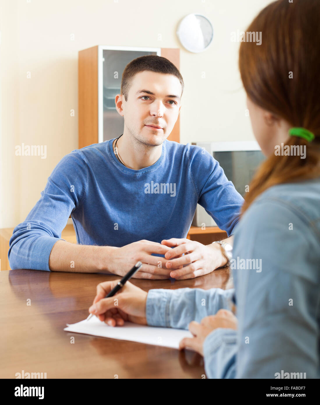Man filling questionnaire for employee with paper at table Stock Photo ...