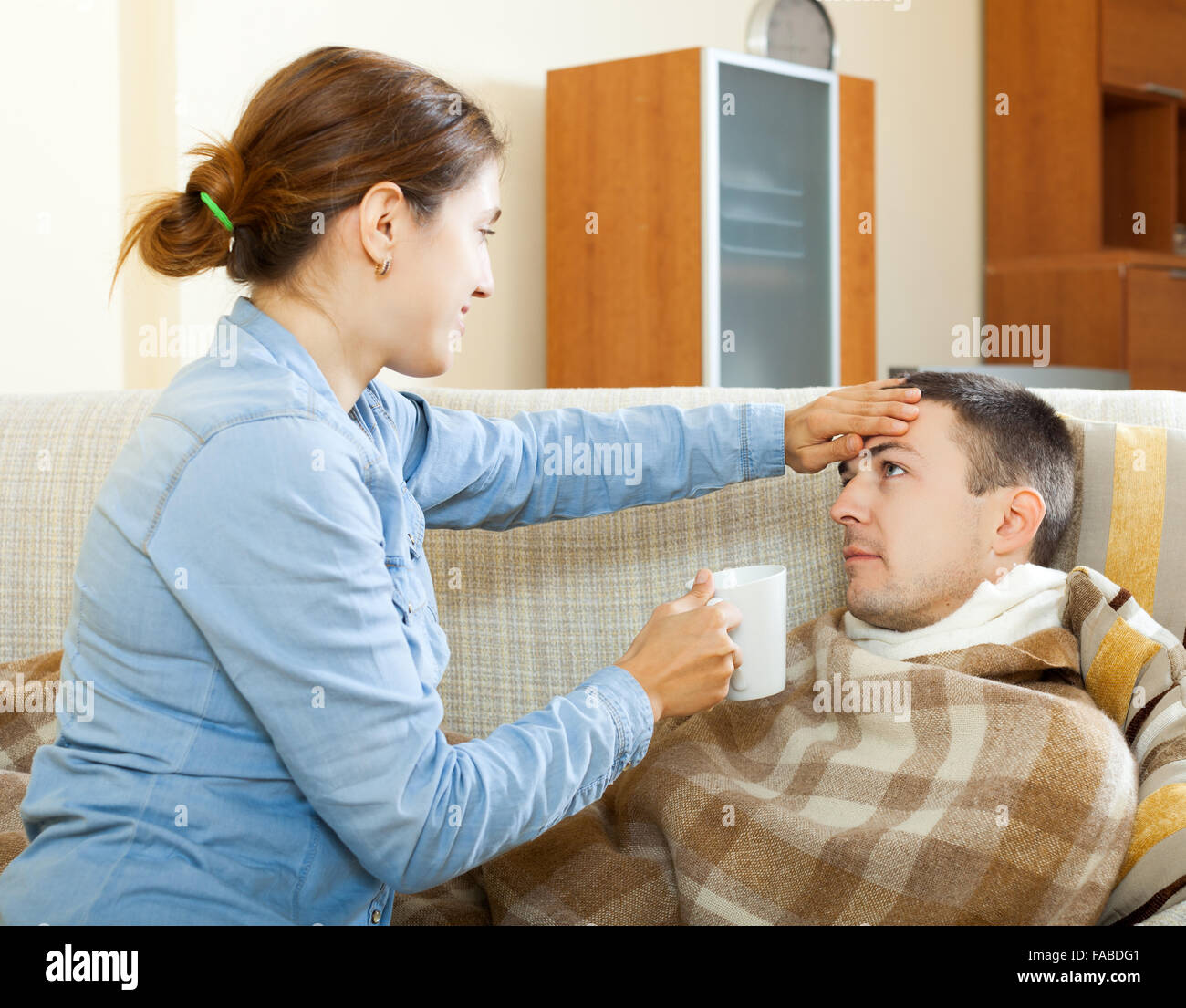Woman caring sick guy home hi-res stock photography and images - Alamy