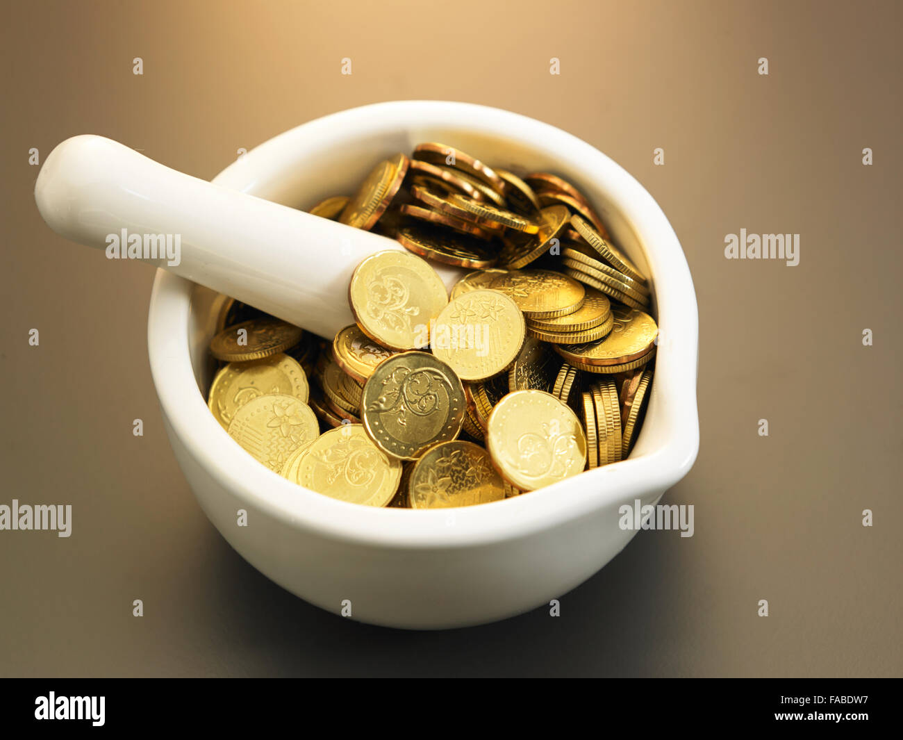 coin inside the kitchenware mortar Stock Photo - Alamy