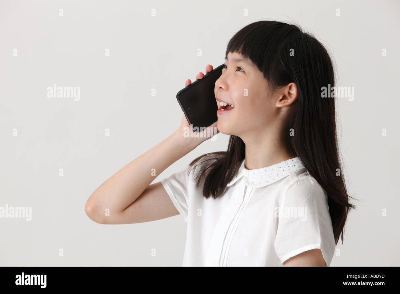 side profile of the chinese girl talking with cellphone Stock Photo - Alamy