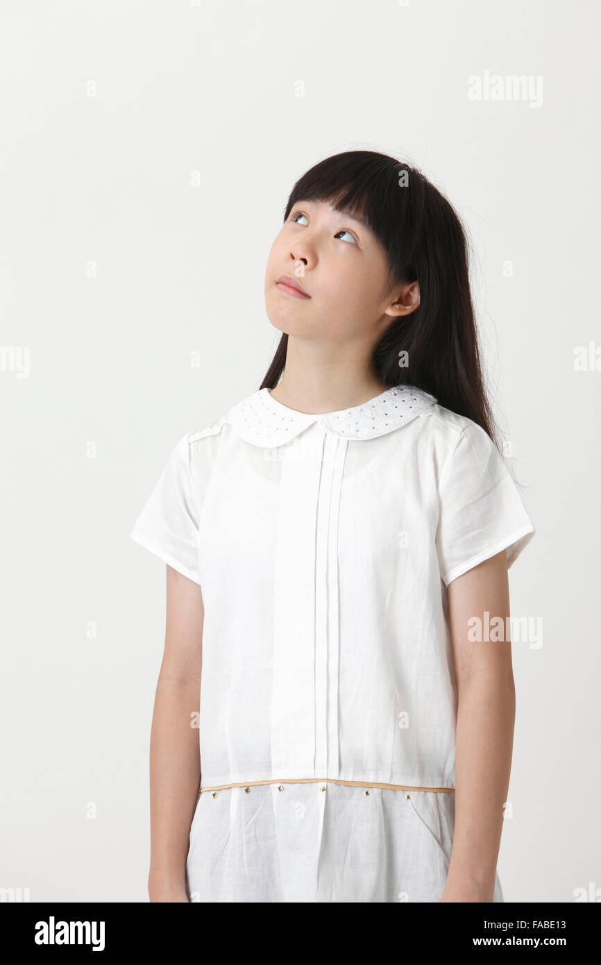 girl with curious expression looking up Stock Photo - Alamy