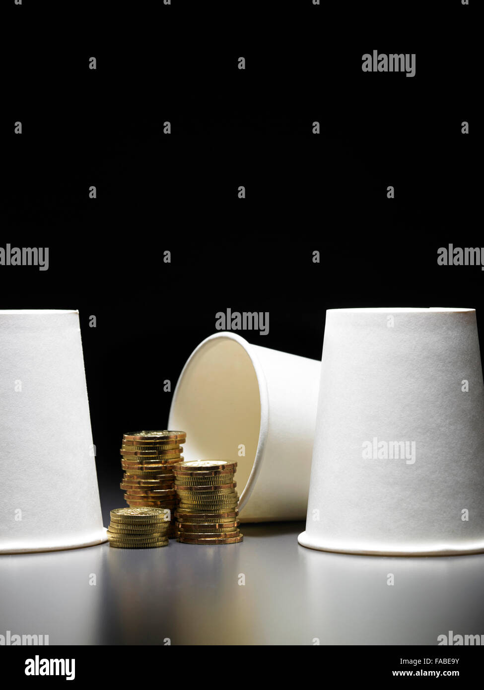 stack of gold coin with three paper cups Stock Photo - Alamy