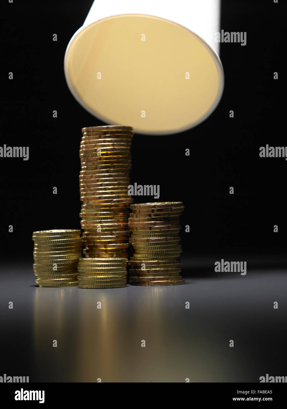 lifting paper cup to show stacks of coins Stock Photo - Alamy