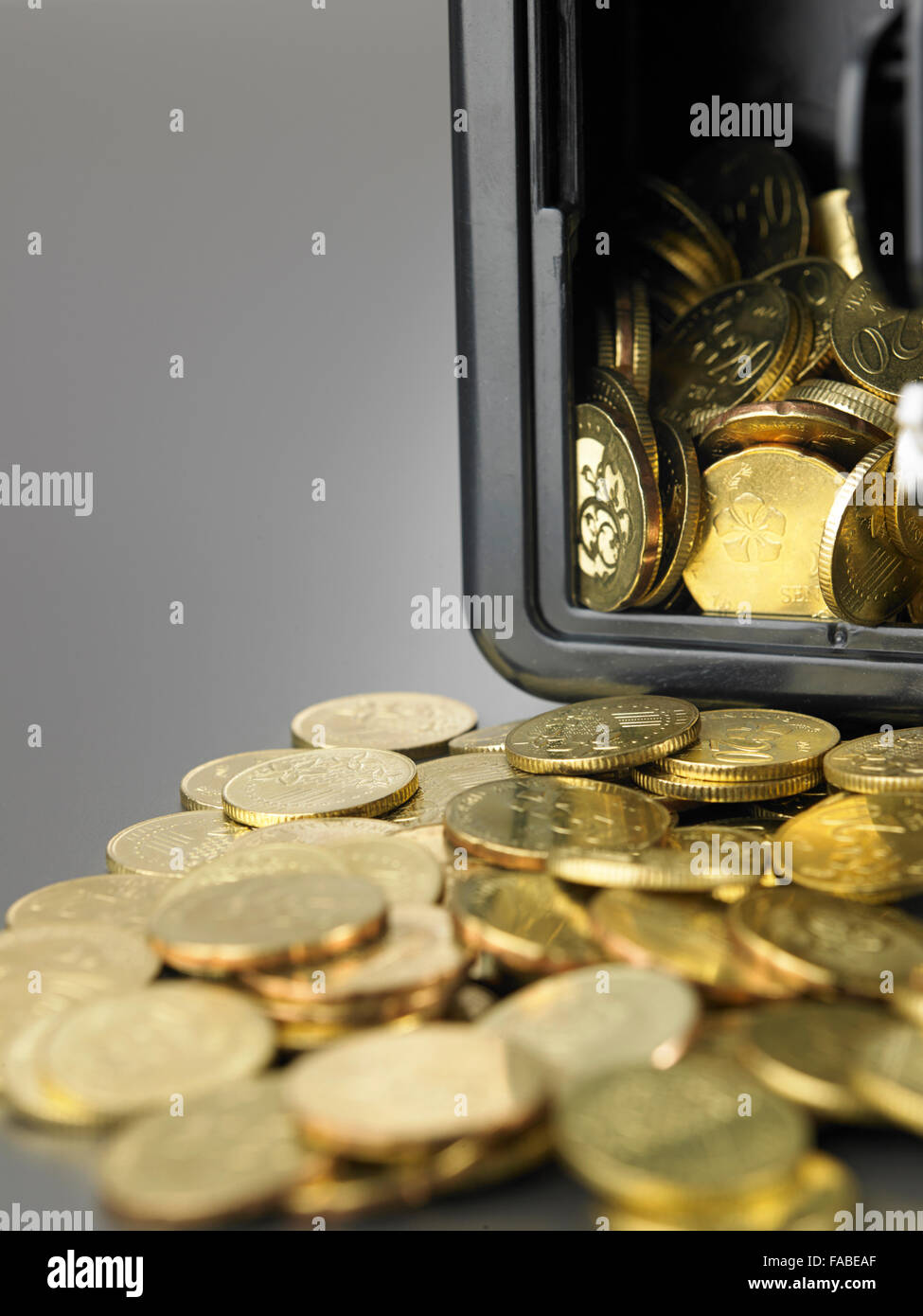 coins in front of the mini safe box Stock Photo - Alamy