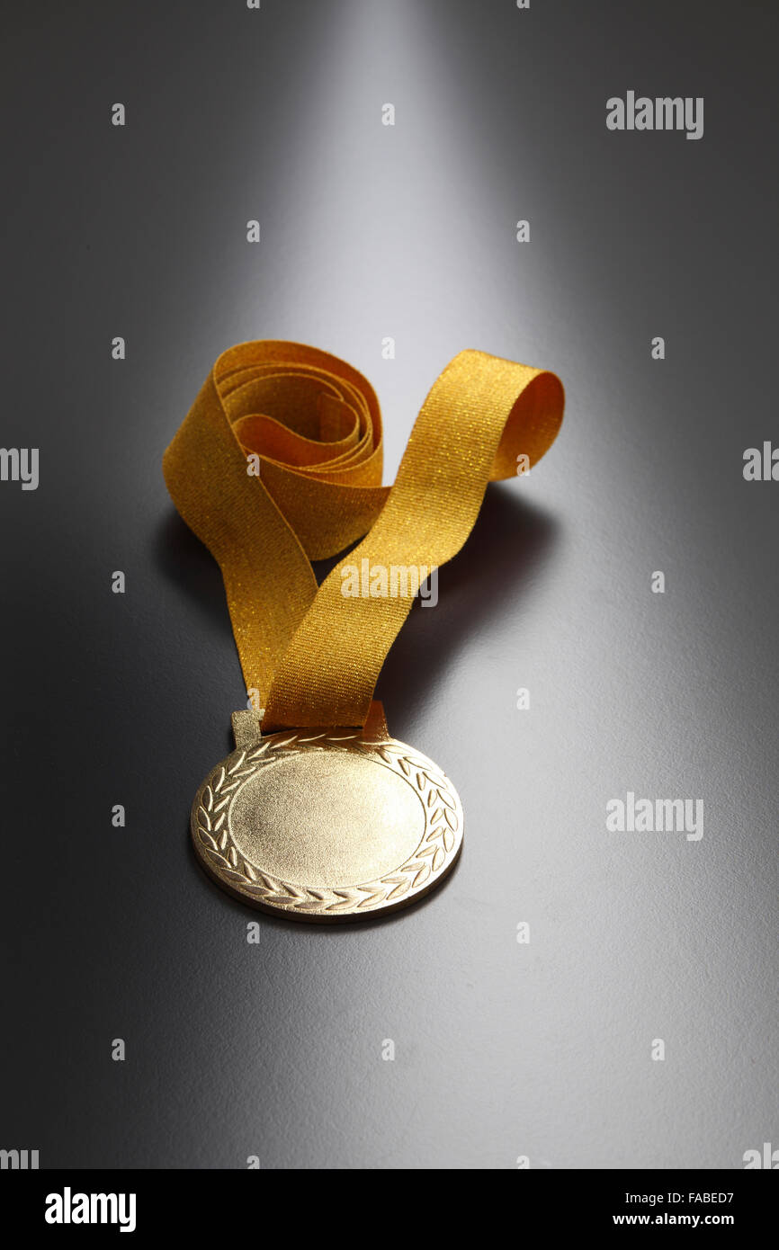 gold color medal on the gray background Stock Photo - Alamy