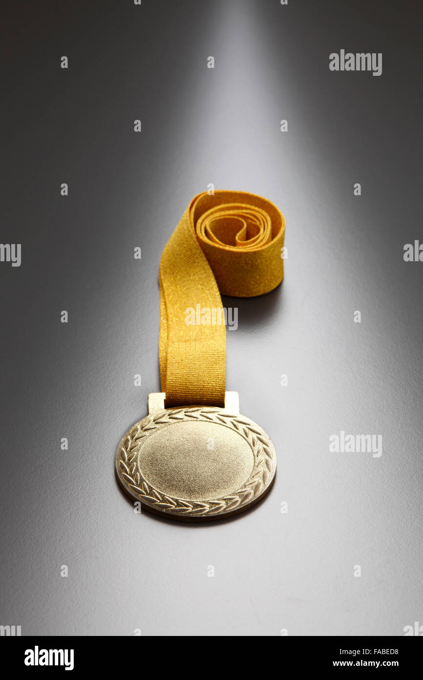 gold color medal on the gray background Stock Photo - Alamy