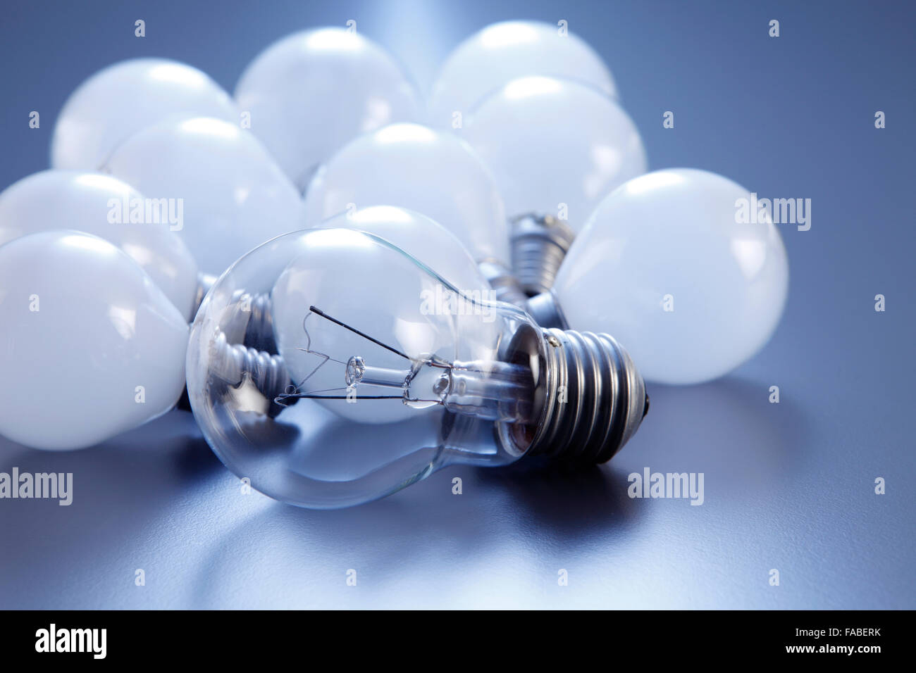 clear light bulb standing up from others Stock Photo - Alamy