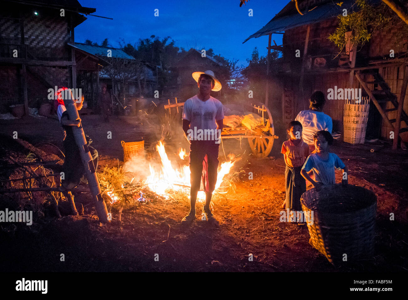 a family around a fire in a village in the Kalaw district of Myanmar ...