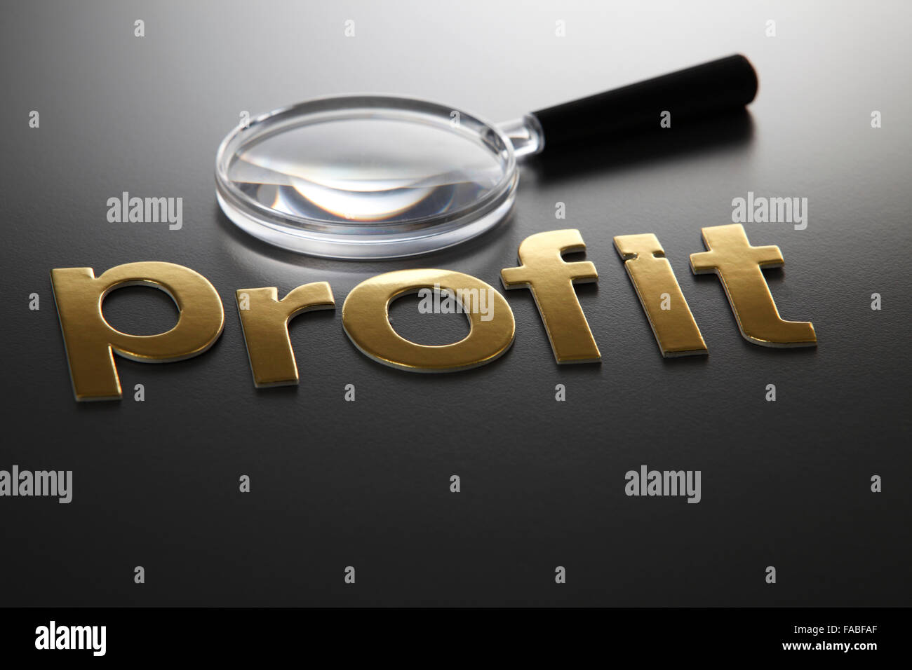 profit and magnifying glass on the gray background Stock Photo - Alamy