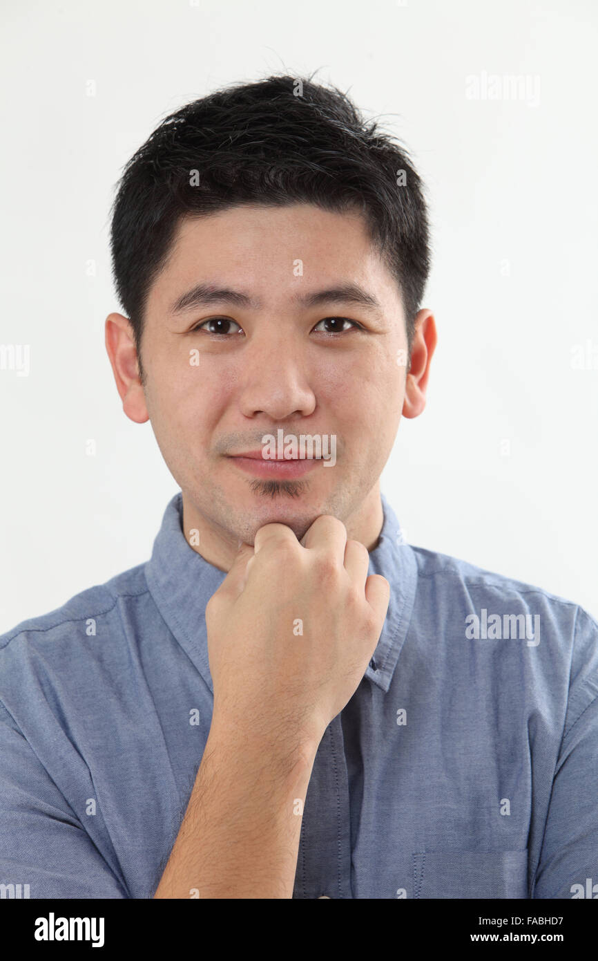 portrait of the chinese man hand on chin Stock Photo - Alamy