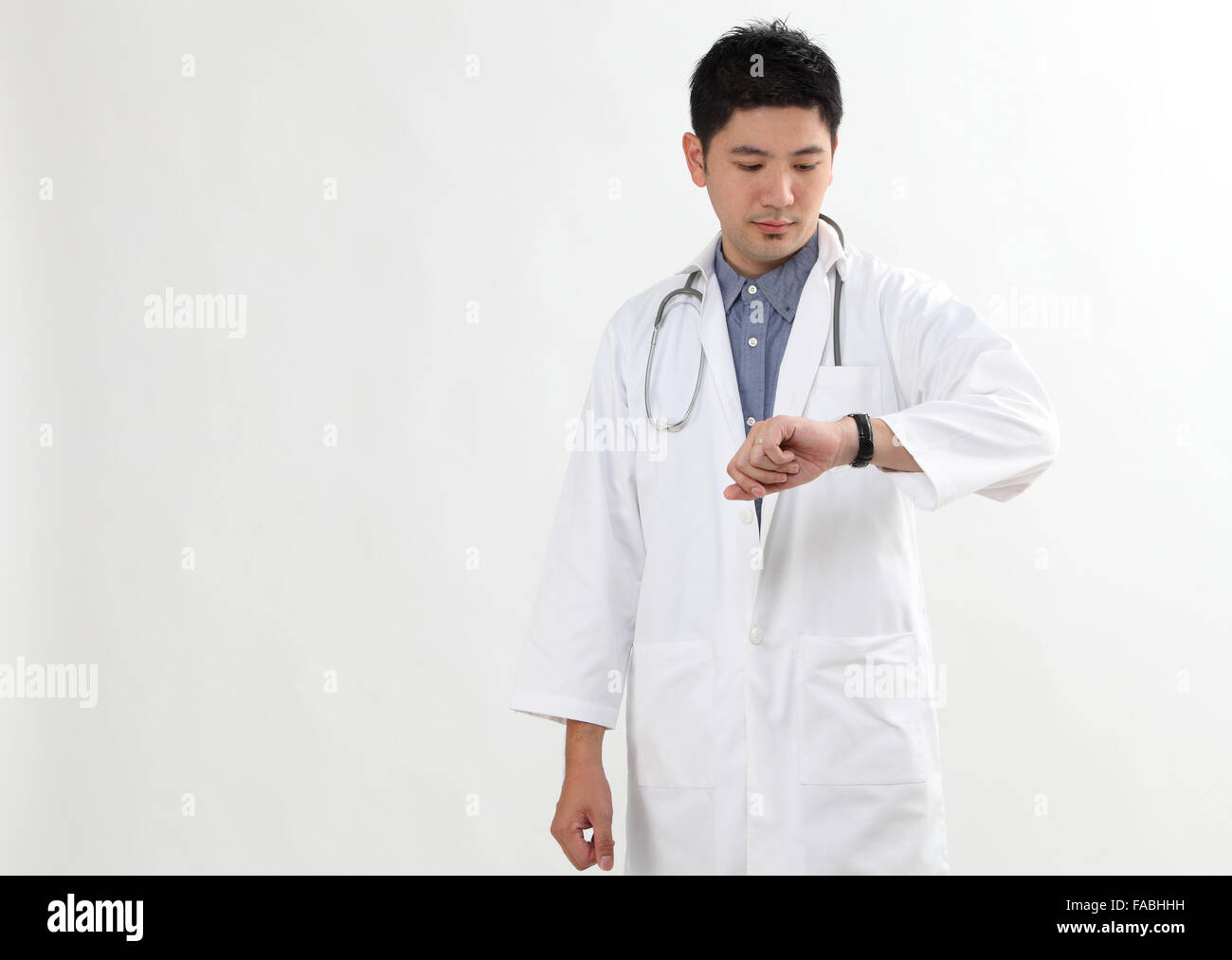 chinese doctor looking at the watch Stock Photo - Alamy