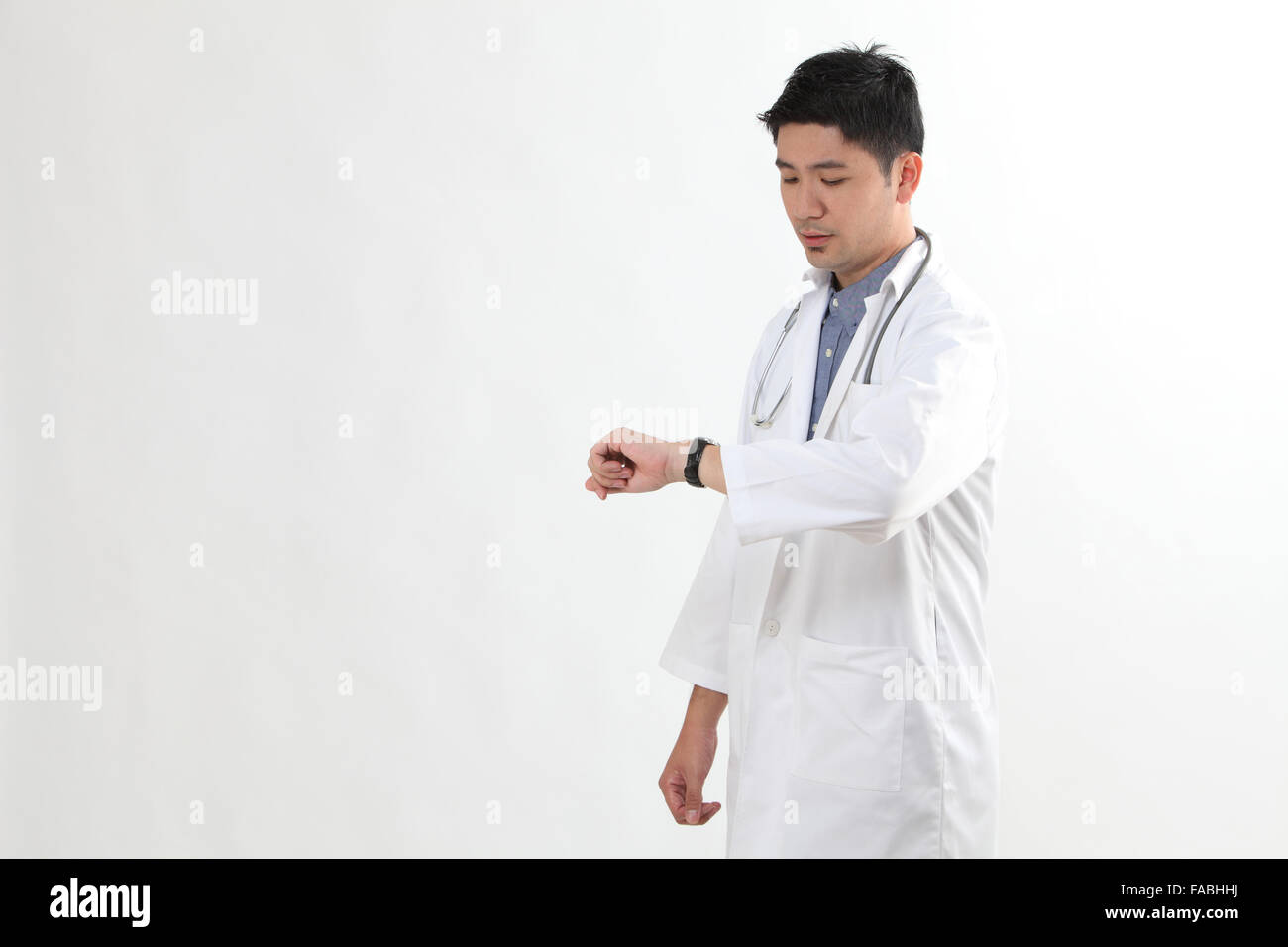 chinese doctor looking at the watch Stock Photo - Alamy