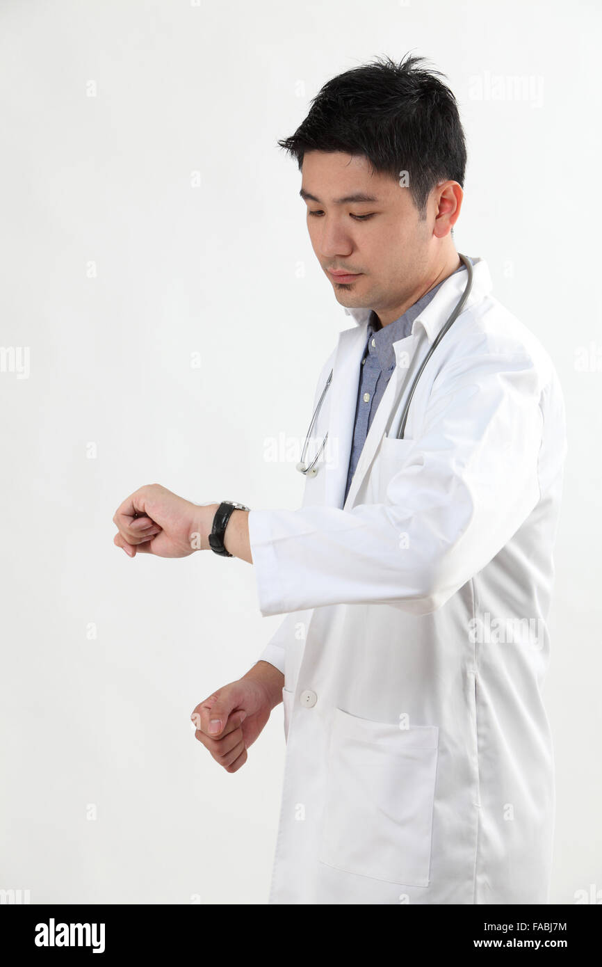 chinese doctor looking at the watch Stock Photo - Alamy