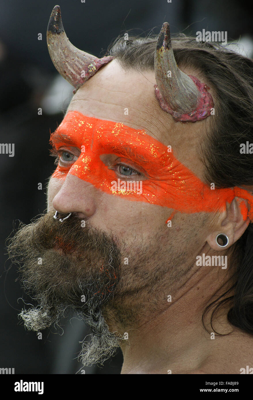 Devil horned man with paint face Stock Photo - Alamy