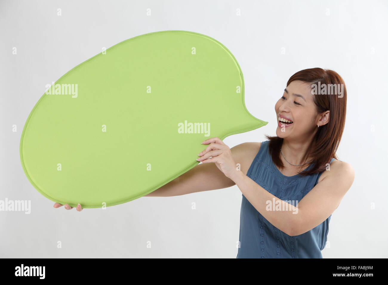 chinese woman holding a speech bubble Stock Photo - Alamy