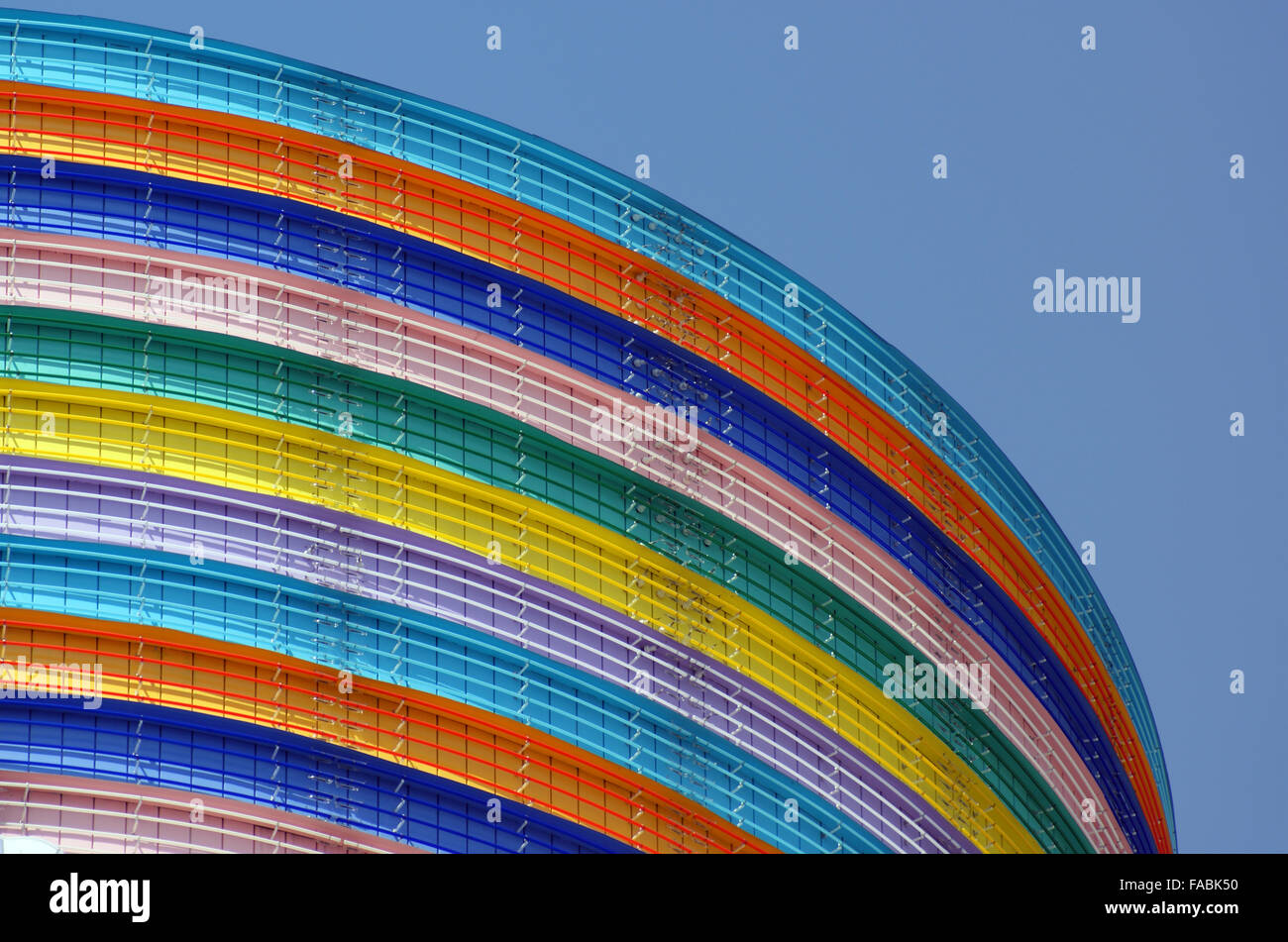 Curved rainbow neon sign around building Stock Photo - Alamy