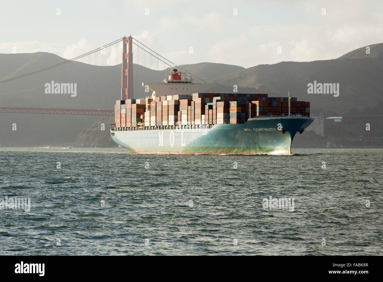 Container ship with the Golden Gate Bridge in the background, San ...