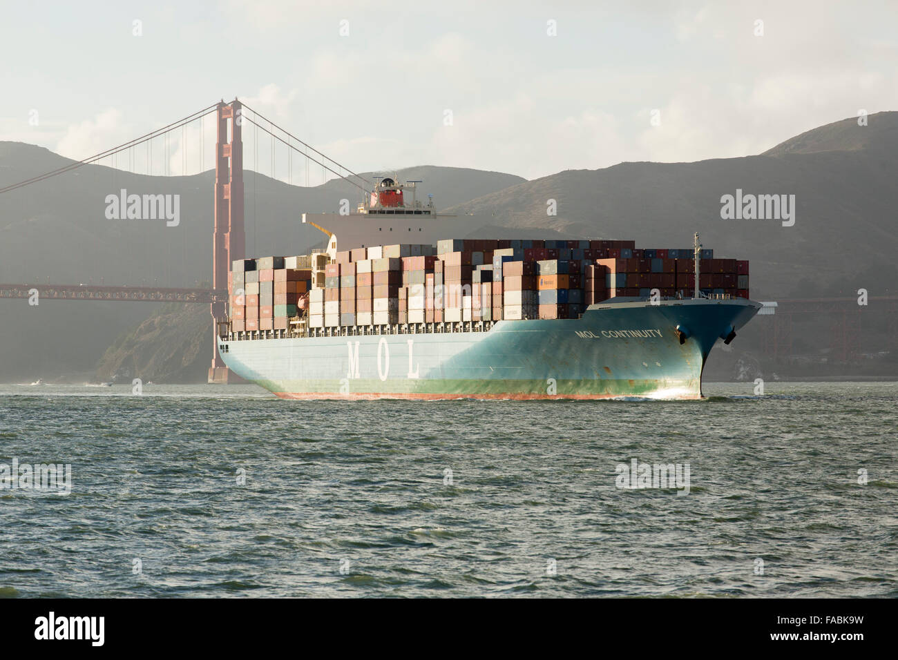 Container ship with the Golden Gate Bridge in the background, San ...
