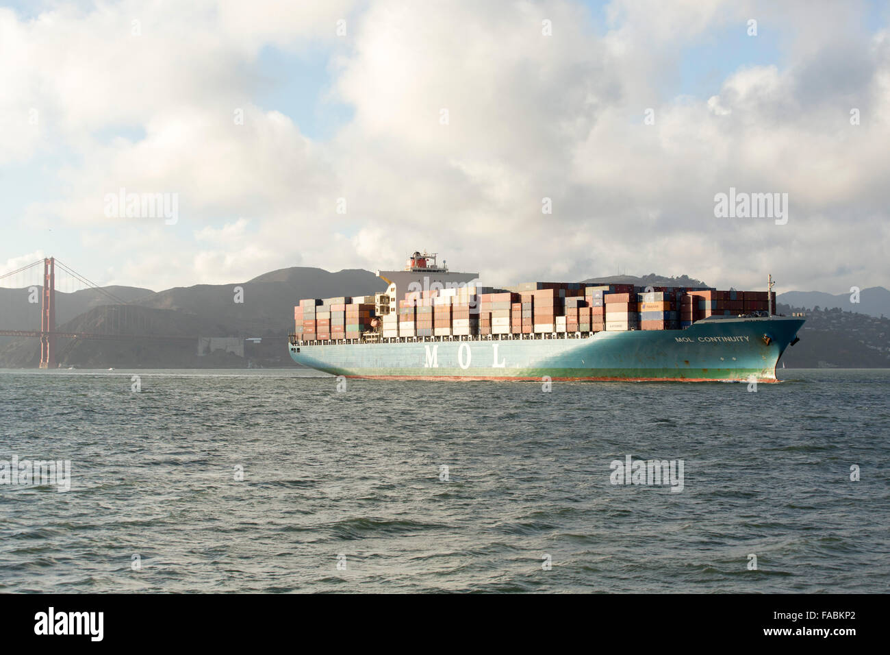 Container ship with the Golden Gate Bridge in the background, San ...