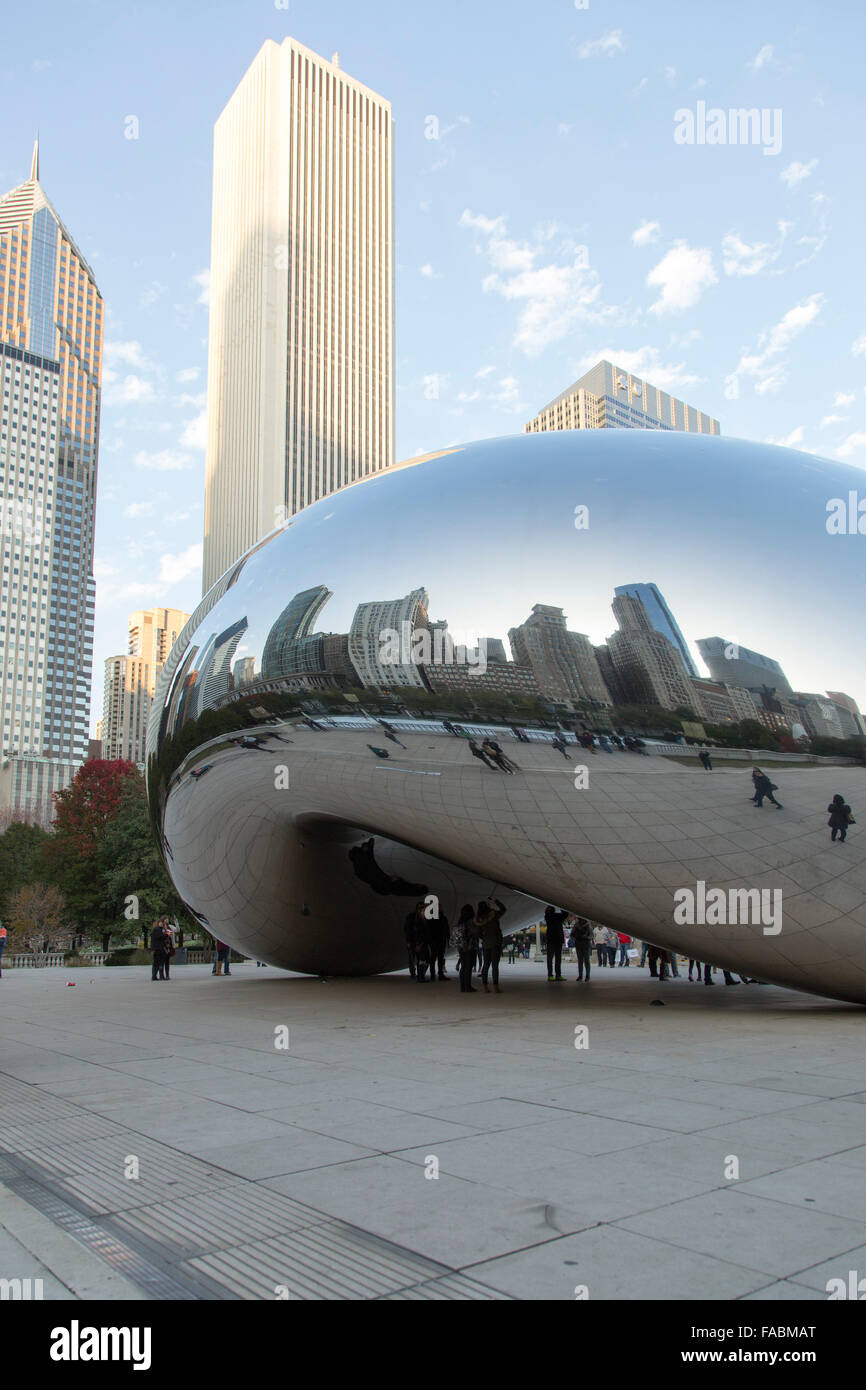 Skyline and visitors reflected in the Cloud Gate steel sculpture by ...