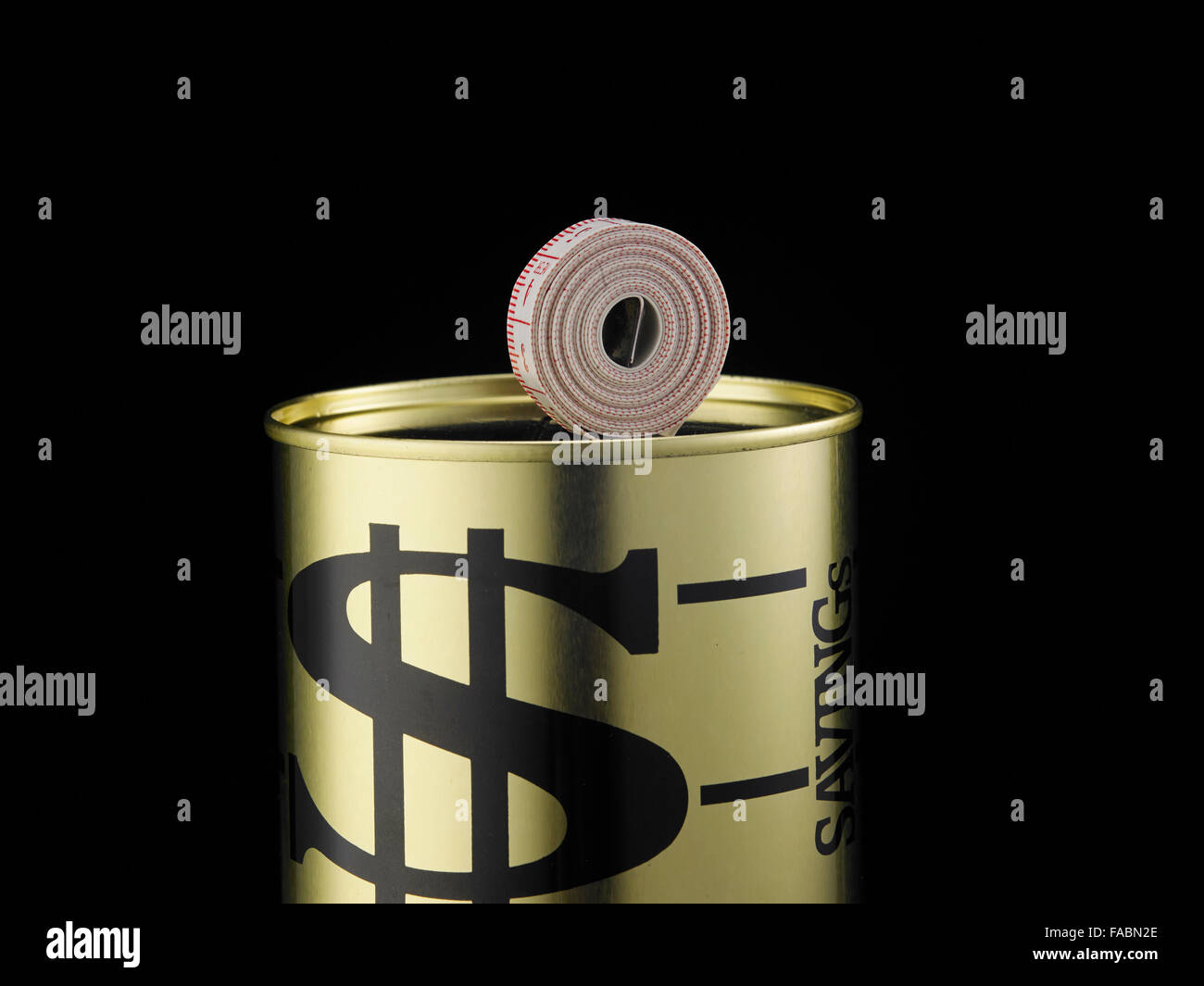 measuring rolled up as a coin on money box Stock Photo - Alamy
