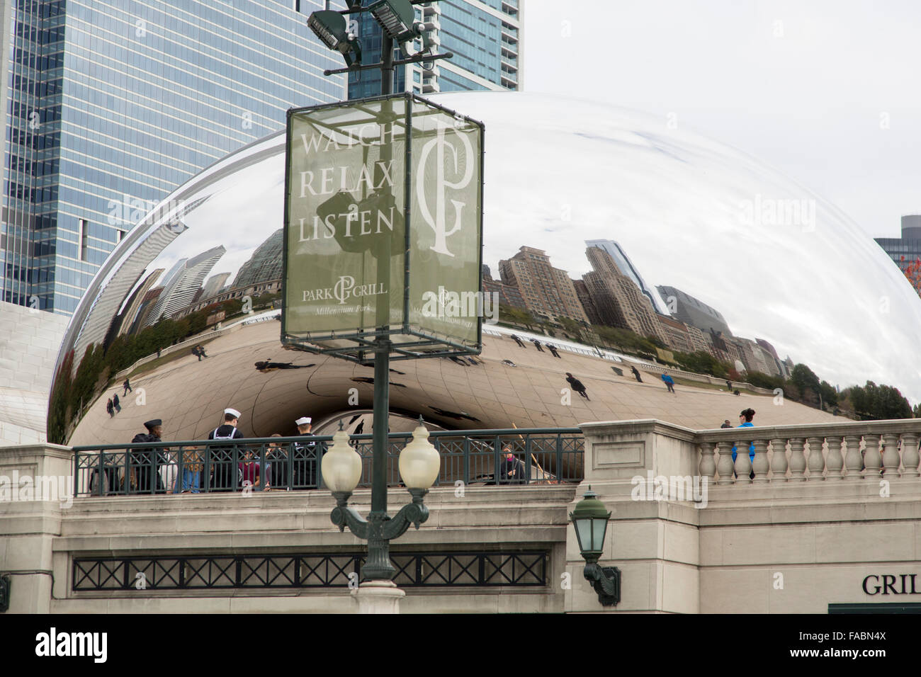Skyline and visitors reflected in the Cloud Gate steel sculpture by ...