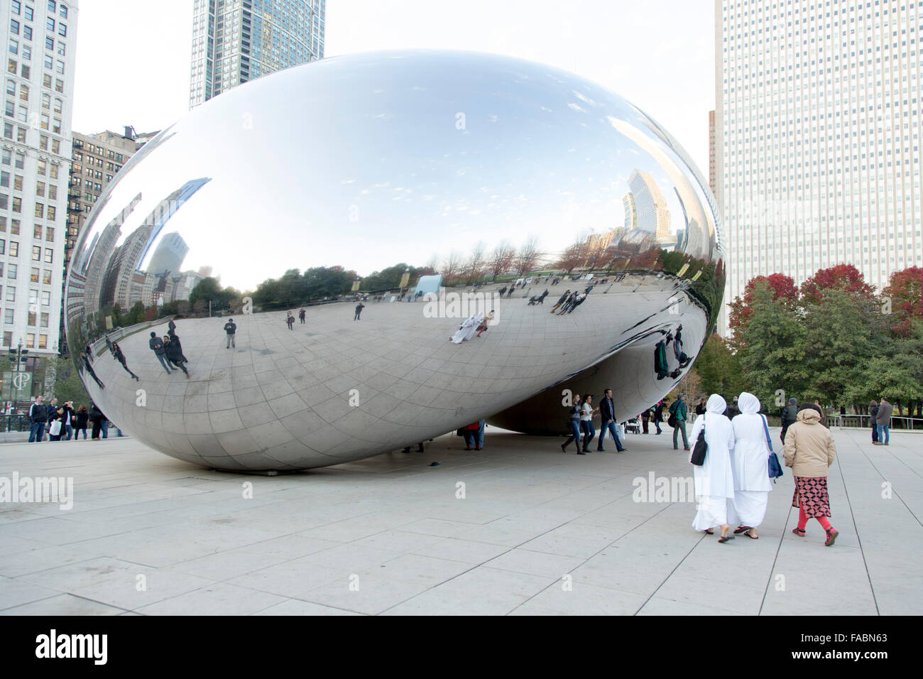 Skyline and visitors reflected in the Cloud Gate steel sculpture by ...