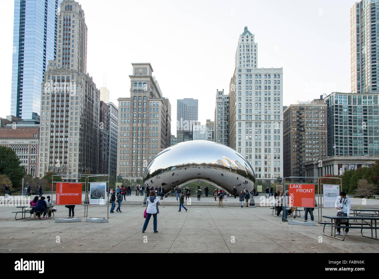 Skyline and visitors reflected in the Cloud Gate steel sculpture by ...