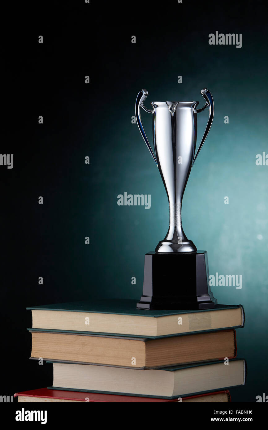 silver trophy on stack of book Stock Photo - Alamy
