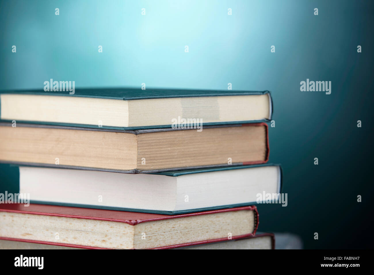 stack of books in front of black board Stock Photo - Alamy