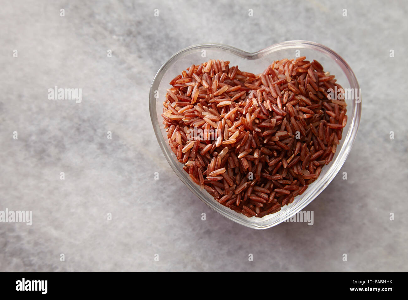 brown rice in a heart shape cointainer Stock Photo - Alamy