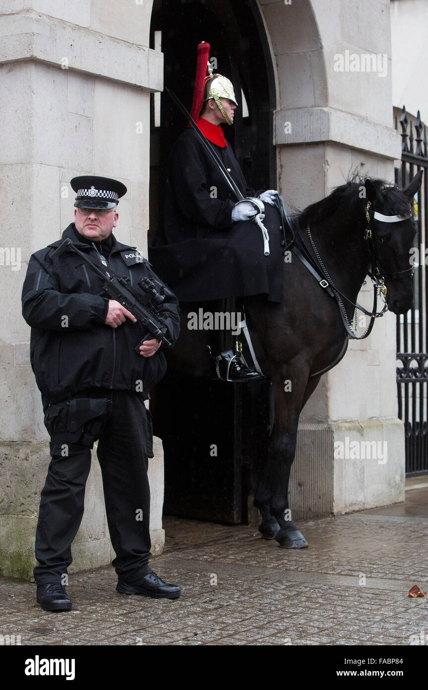 An armed British police officer patrols the streets of London Stock ...