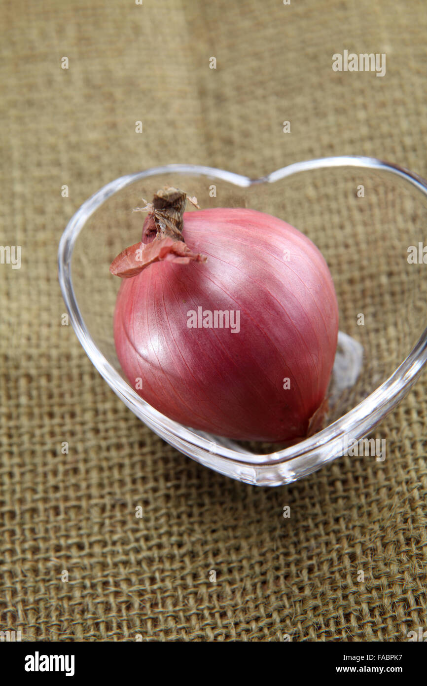 onion in a heart shaped bowl Stock Photo - Alamy