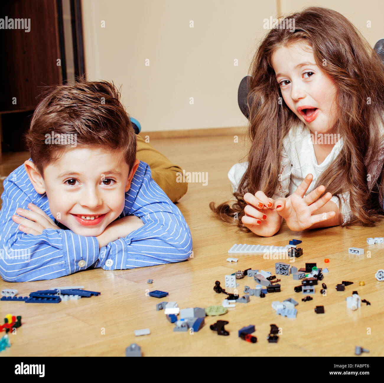 funny cute children playing lego at home, boys and girl smiling, first ...